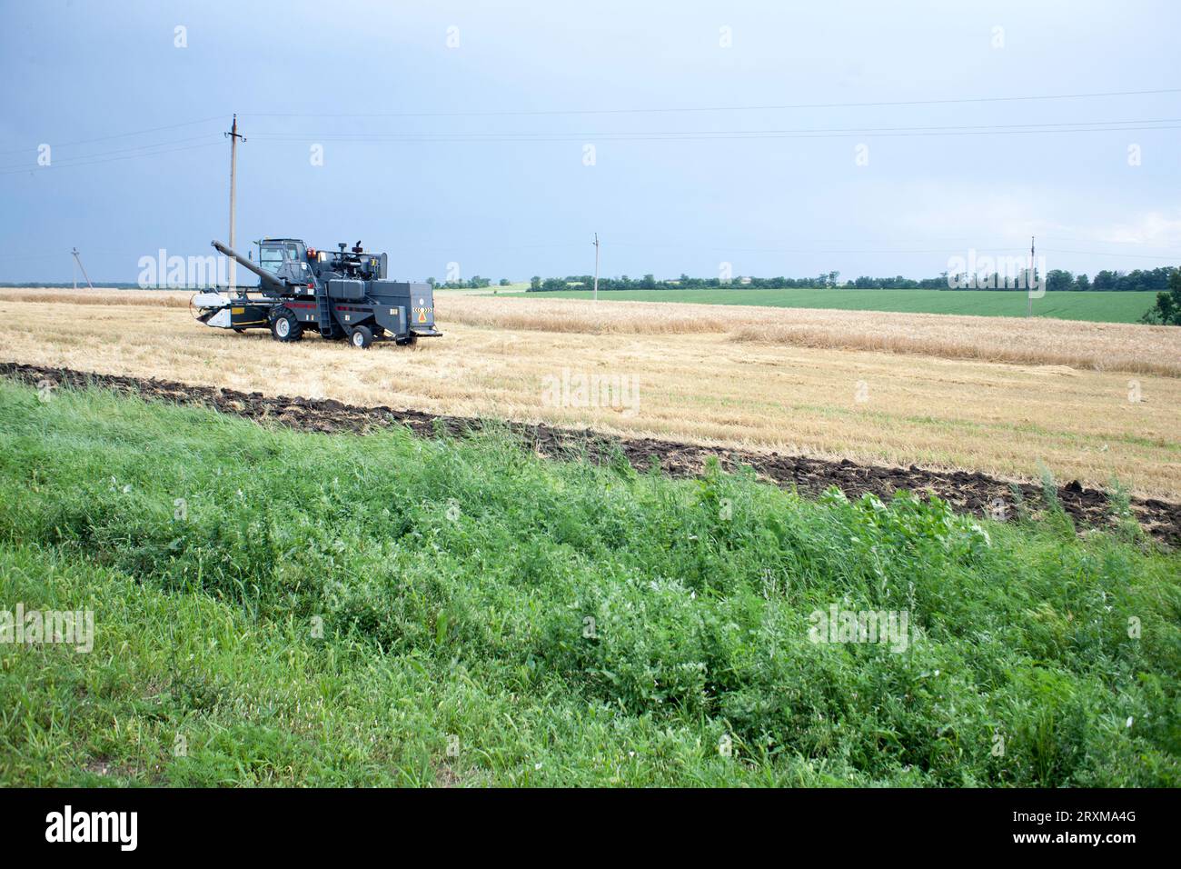 Old Russian grain harvester combine in the field. Russian combine ...