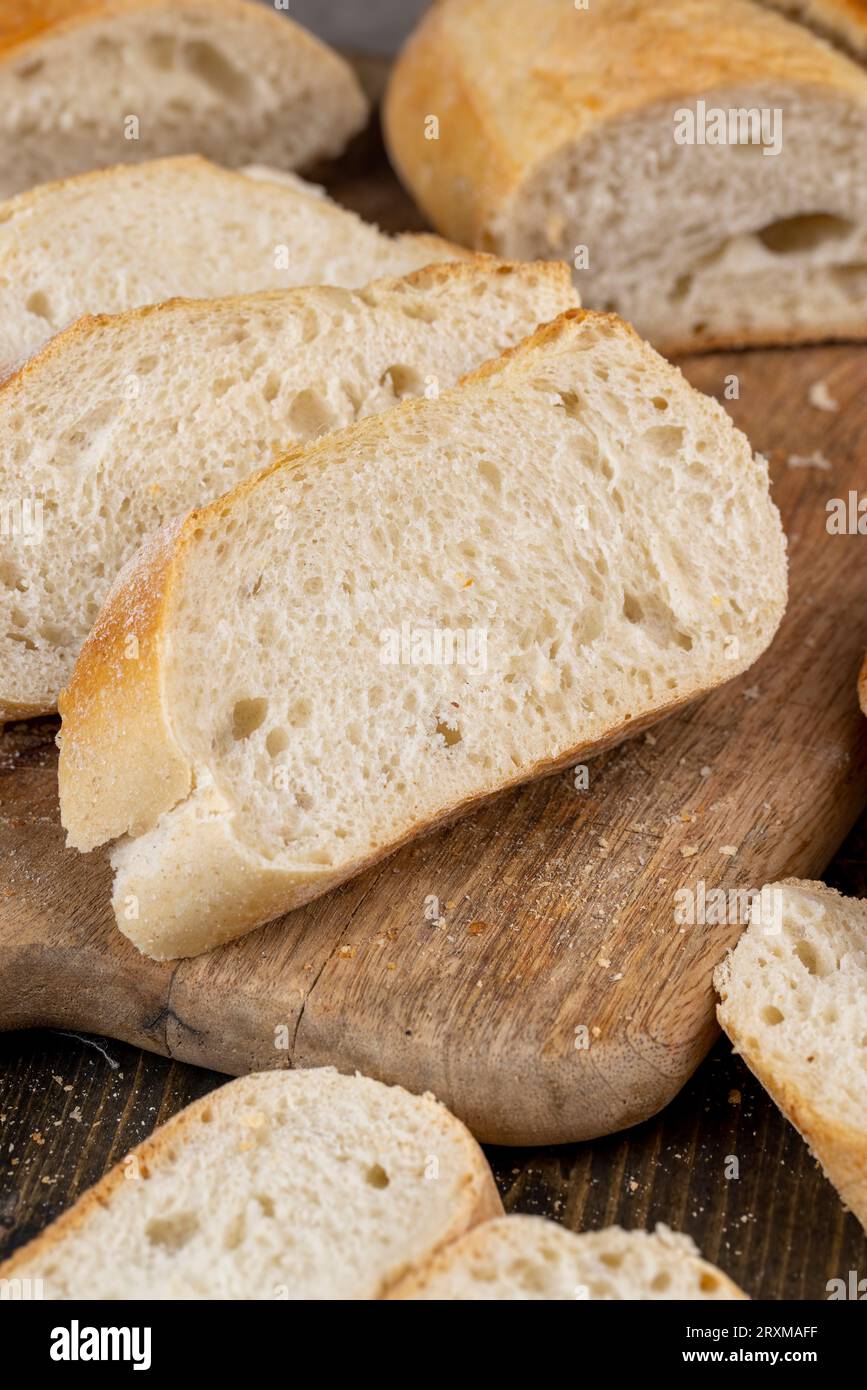 slices of sliced loaf of wheat bread, a loaf of fresh bread cut into ...