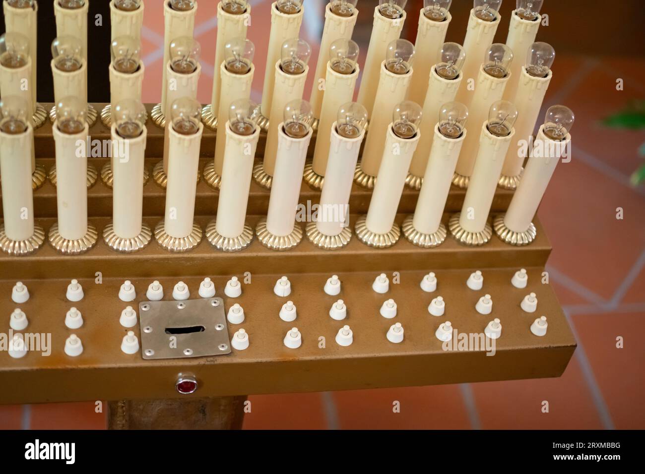 Candles of supplication and wishes on altar of Church with slot to ...