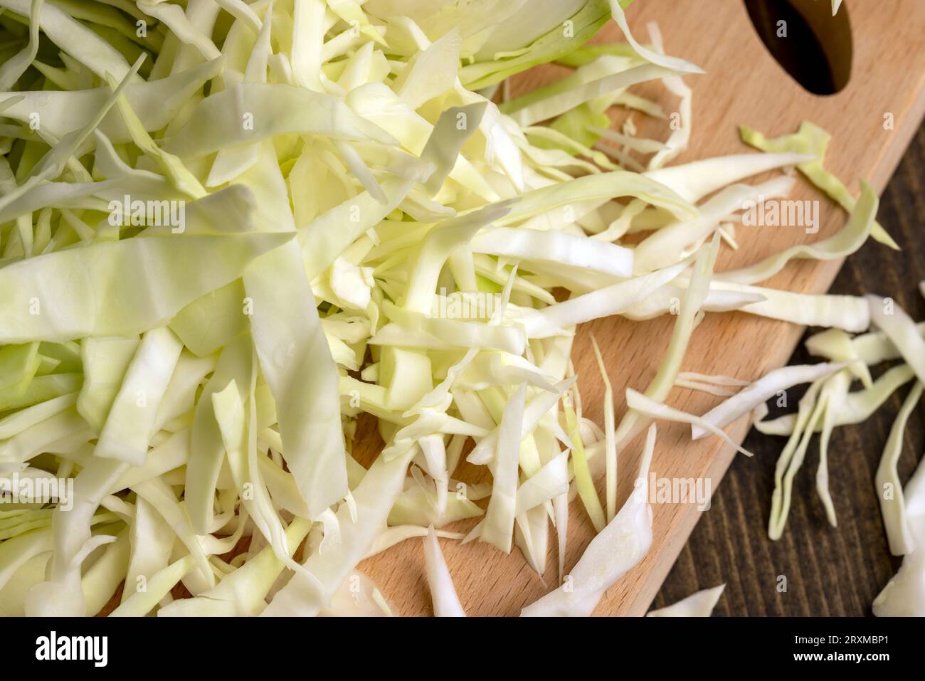 Sliced white cabbage on the table, salad preparation using fresh white ...