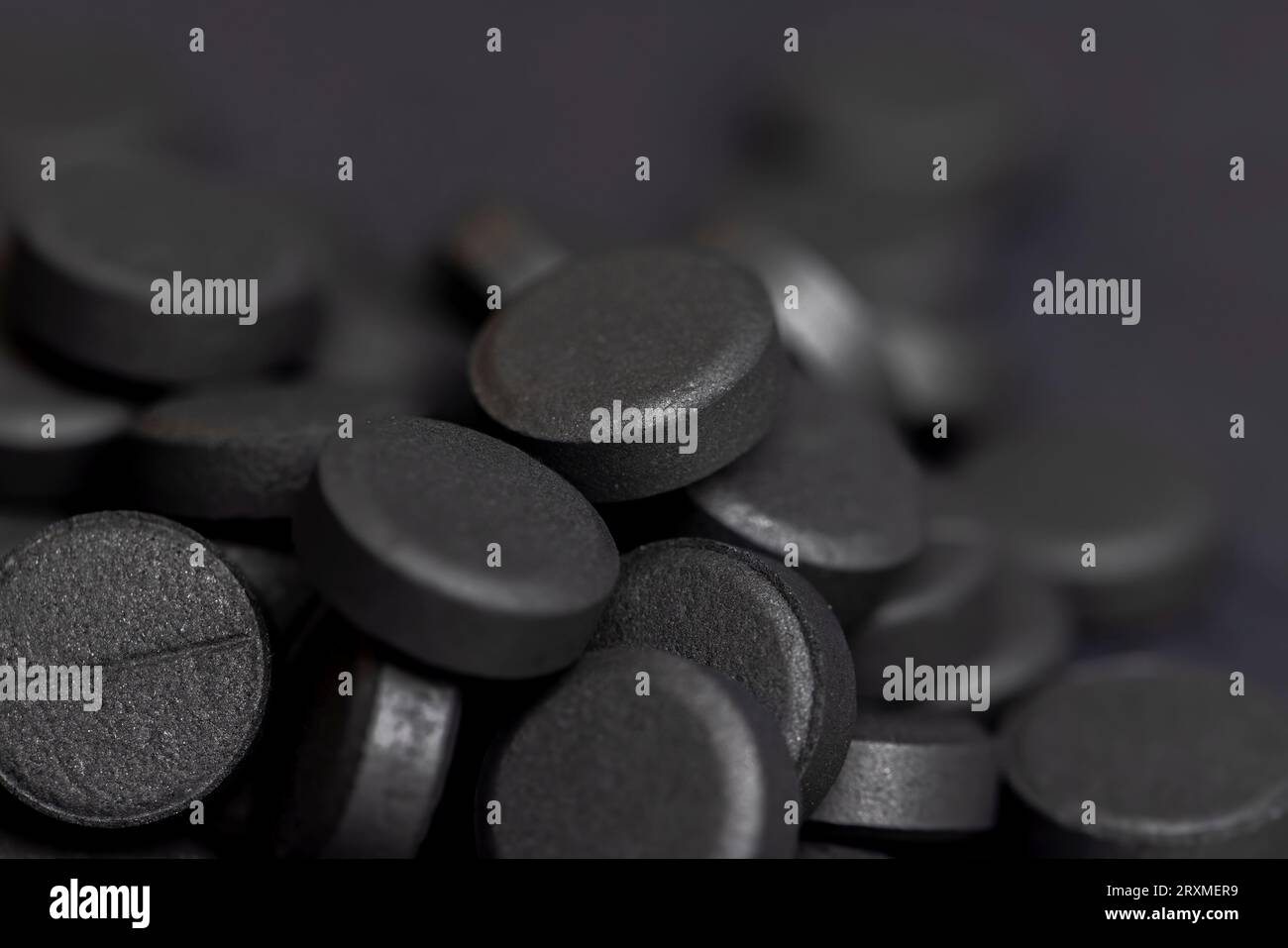 Open and unpacked tablets of black color close-up, several of the same ...