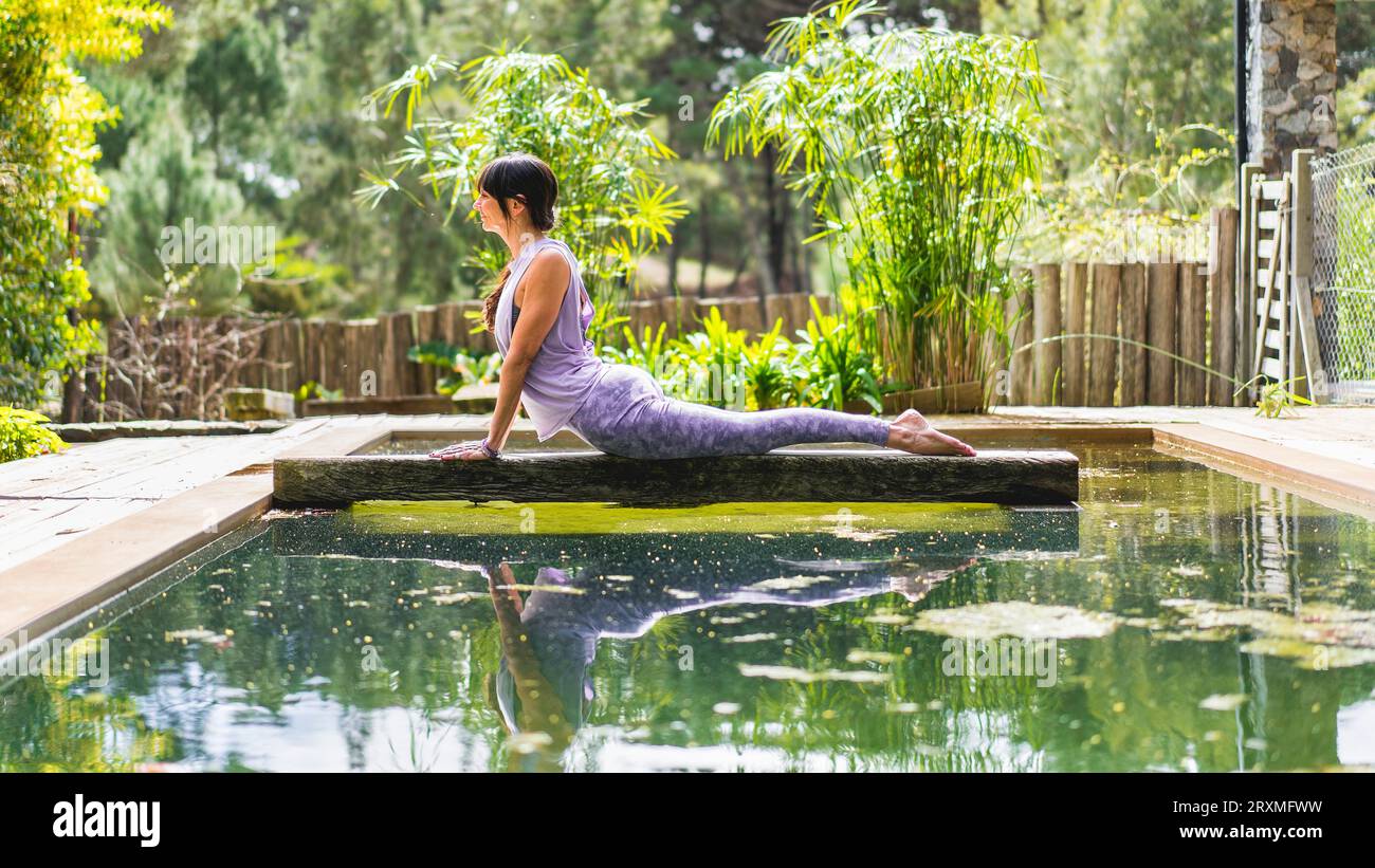 Woman practicing yoga, lying in Cobra pose (Bhujangasana exercise ...