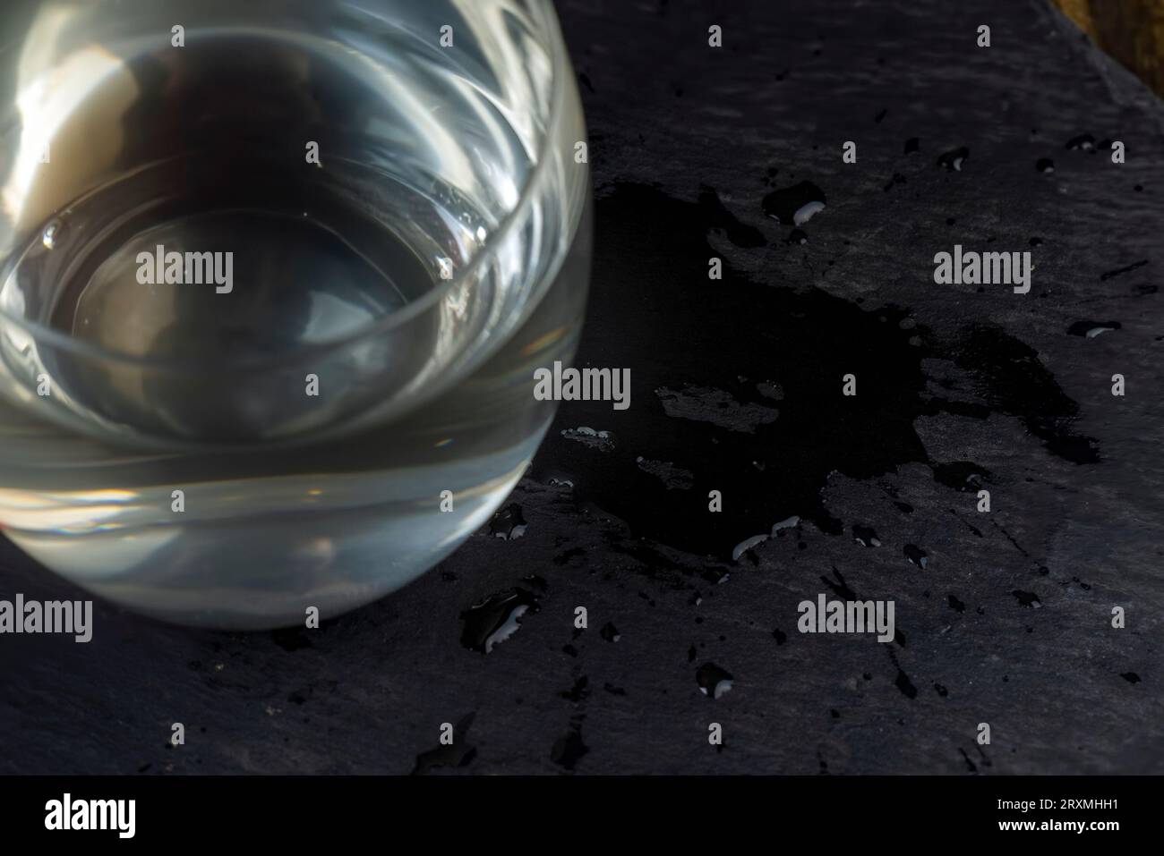 Transparent water glass and wet objects next to the glass, several ...