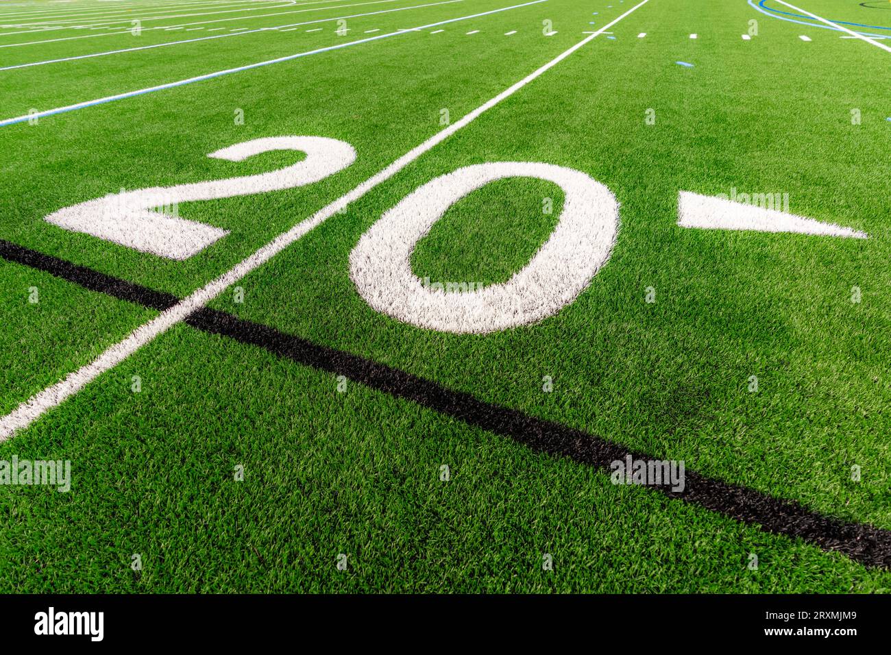 Synthetic turf football field twenty, 20, yard line in white Stock ...