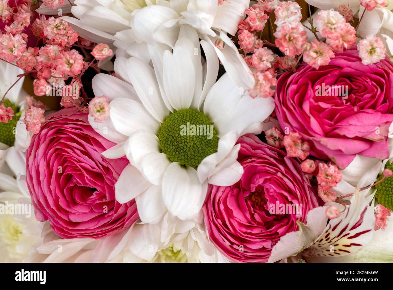 using different types of flowers to create a small bouquet for a ...
