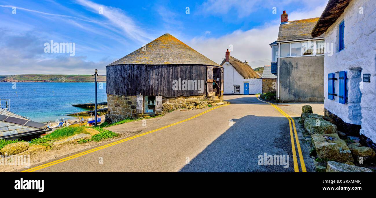Asphalt road stretching between coastal houses, Sennen Cove, England ...