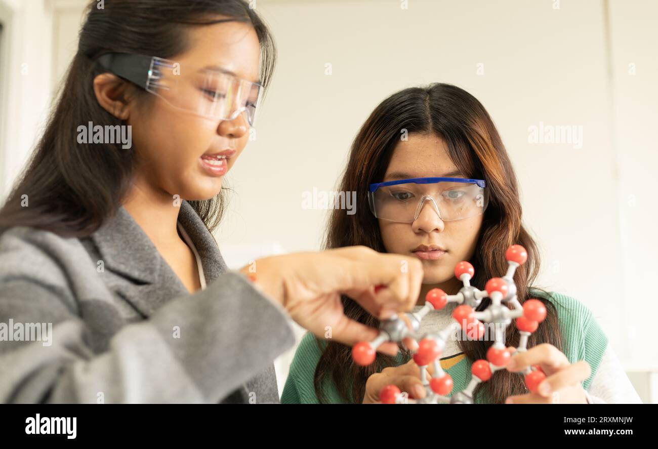 STEM education concept. Asian children in laboratory research an ...