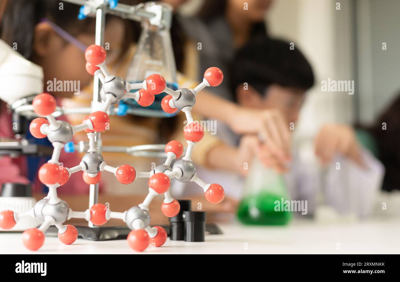 STEM education concept. Asian children in laboratory research an ...