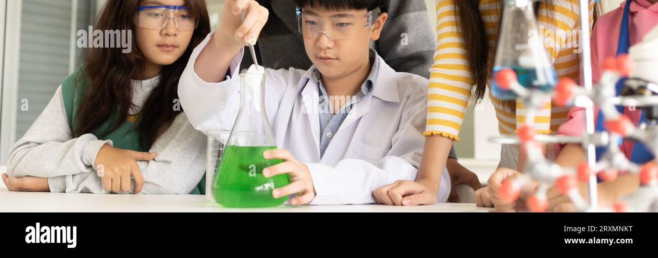 STEM education concept. Asian children in laboratory research an ...
