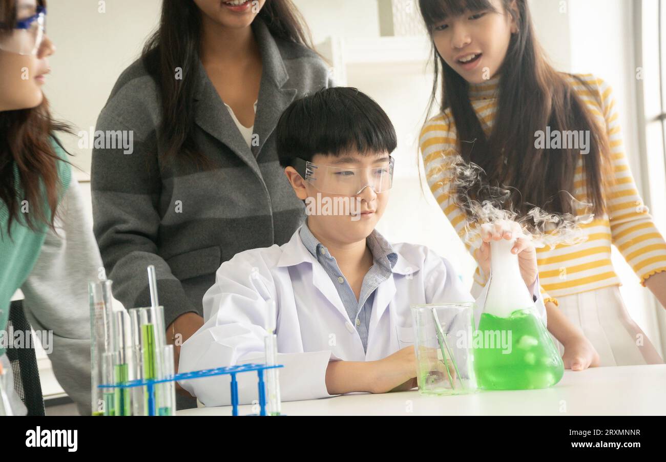 STEM education concept. Asian children in laboratory research an ...