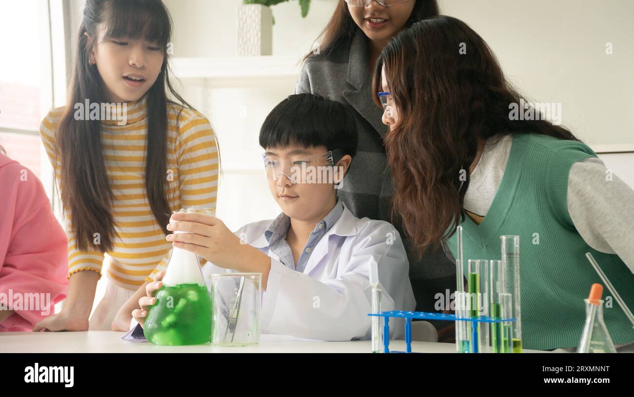 STEM education concept. Asian children in laboratory research an ...