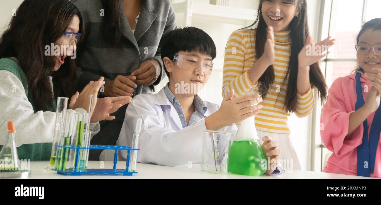 STEM education concept. Asian children in laboratory research an ...