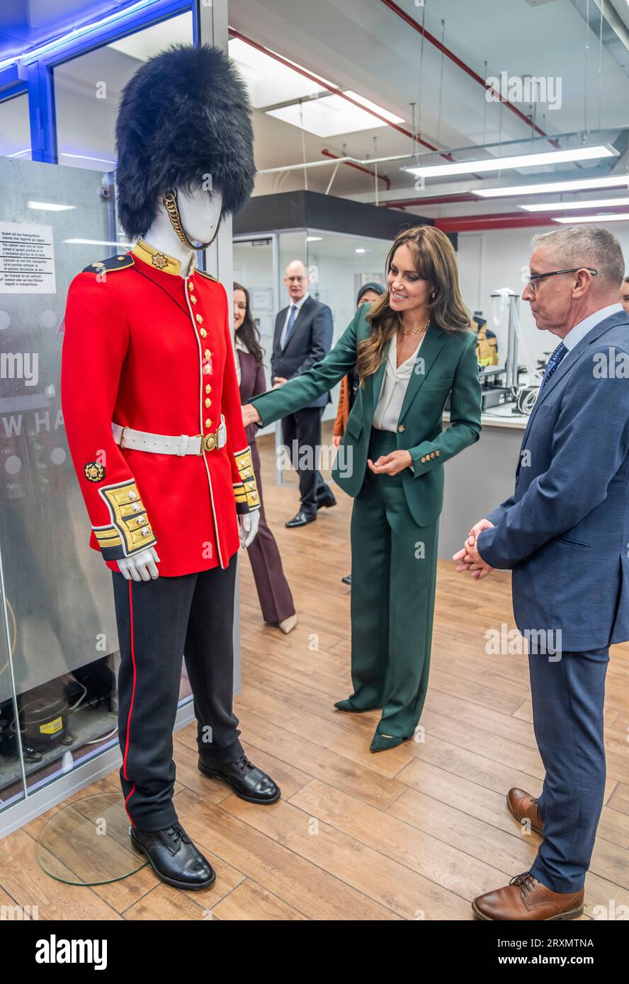 The Princess of Wales looks at a Guardsmans scarlet tunic during a ...