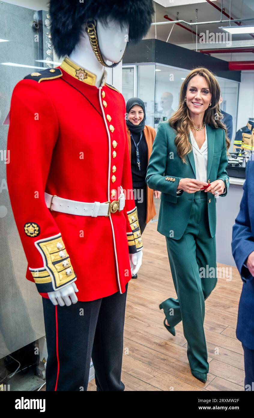The Princess of Wales looks at a Guardsmans scarlet tunic during a ...