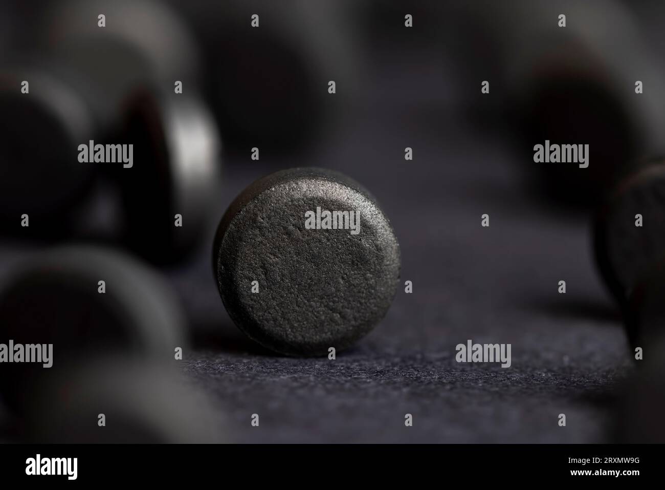 Open and unpacked tablets of black color close-up, several of the same ...