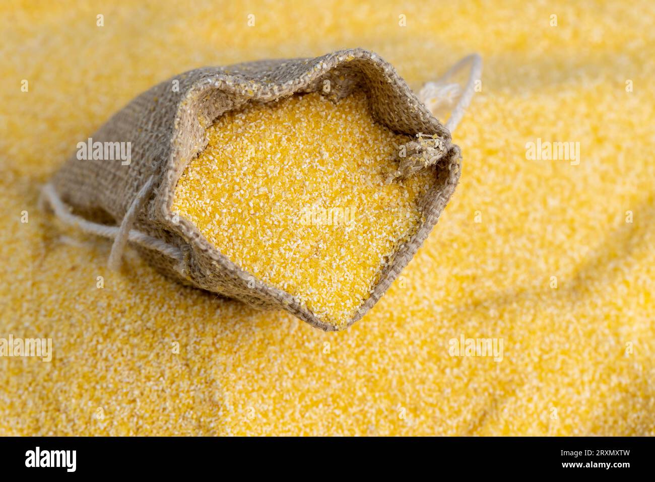 Dry corn flour poured into a linen bag for making porridge, high ...