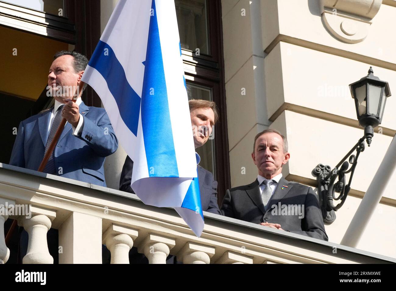 Israel's ambassador to Poland, Yacov Livne, left, waves an Israeli ...