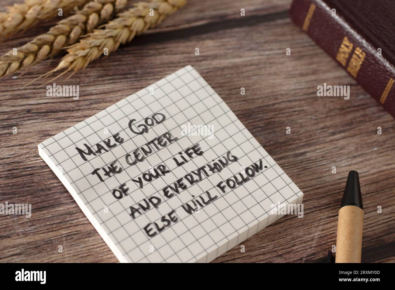 Handwritten inspiring quote with holy bible book and wheat stalk on ...