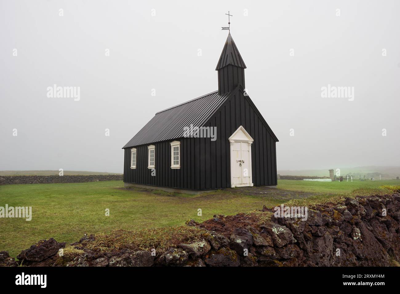 Veiled in fog, Iceland's black church stands as a solemn sentinel ...