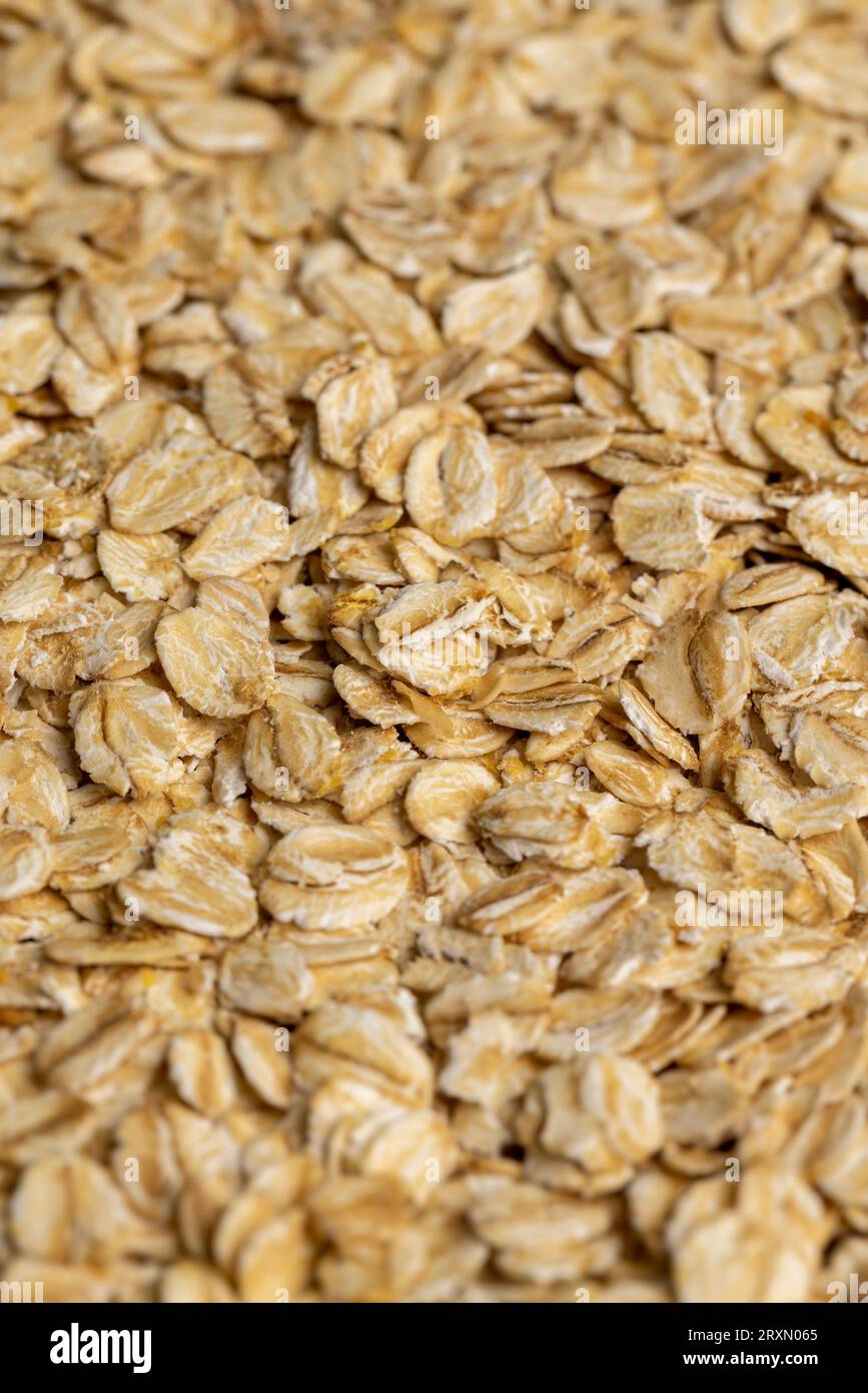 Poured a large amount of oat flakes close-up, background of raw ...
