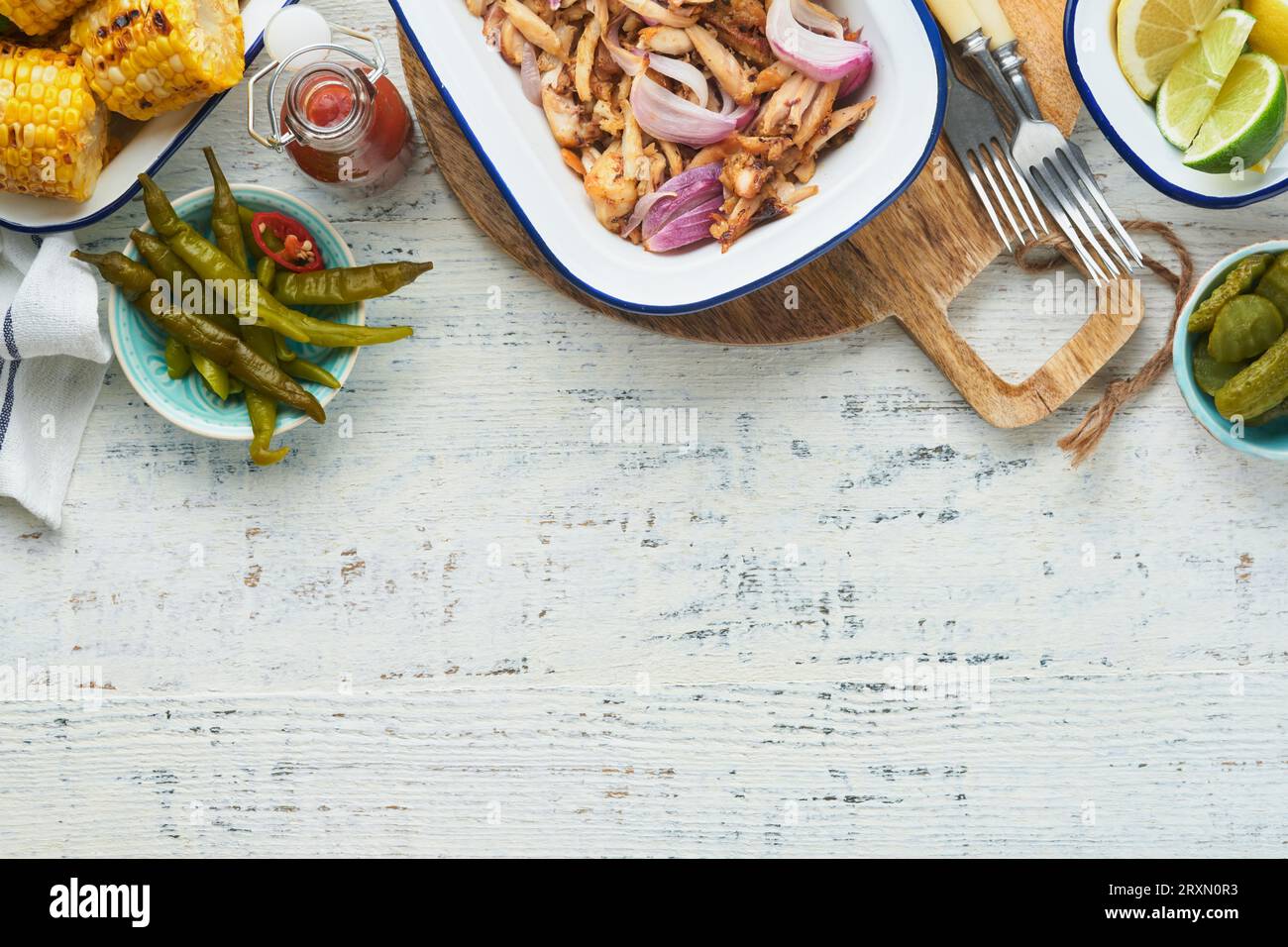 Pulled bbq chicken with baked onions on serving platter, bbq corn ...