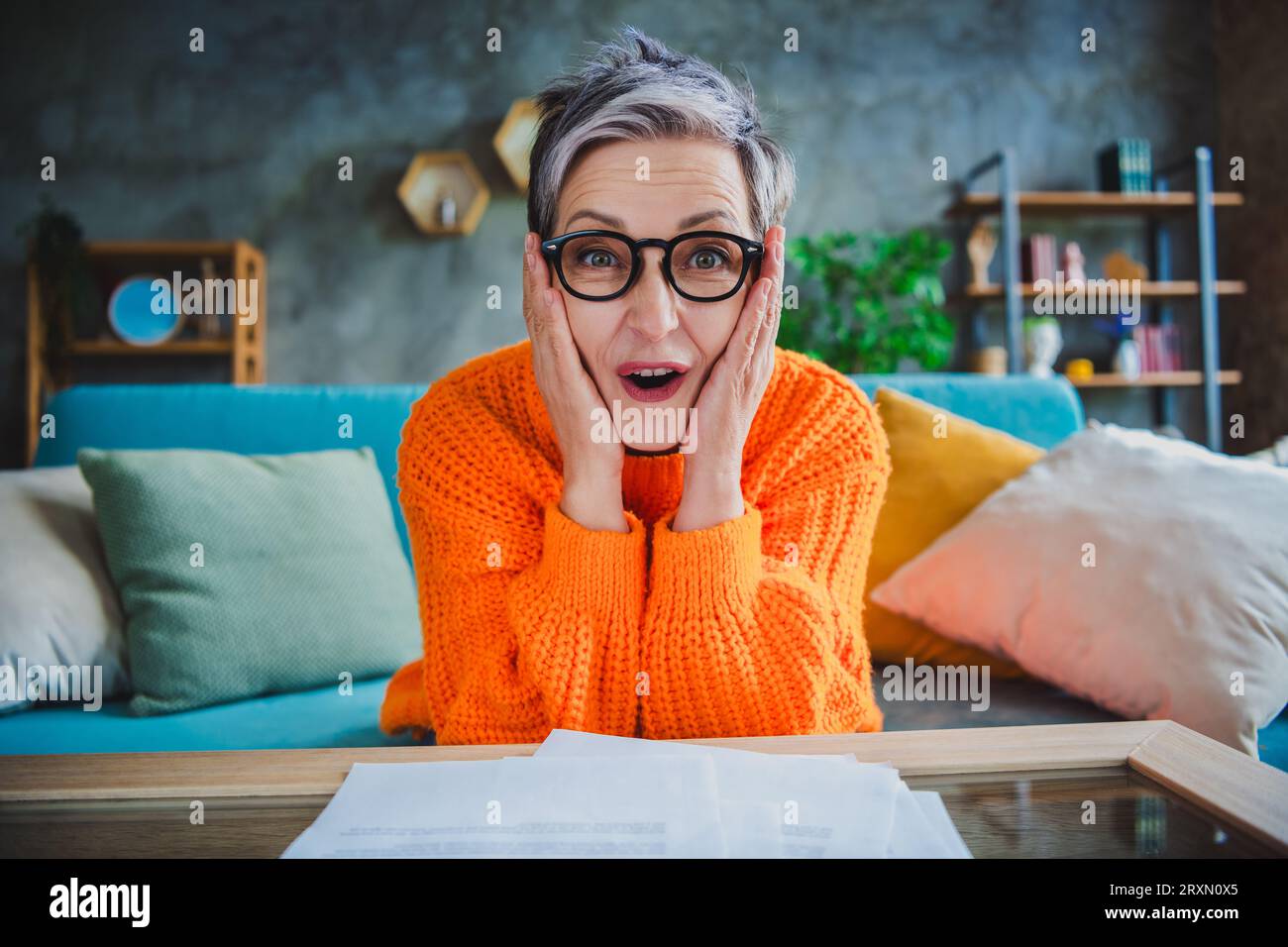 Photo of happy impressed mature lady dressed orange sweater arms cheeks ...