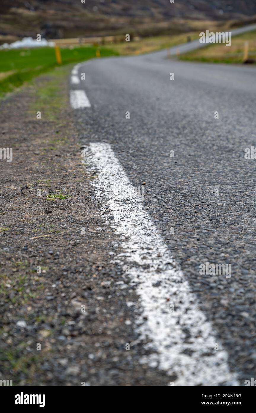 White mark on asphalt street, iceland, vertical shot Stock Photo - Alamy