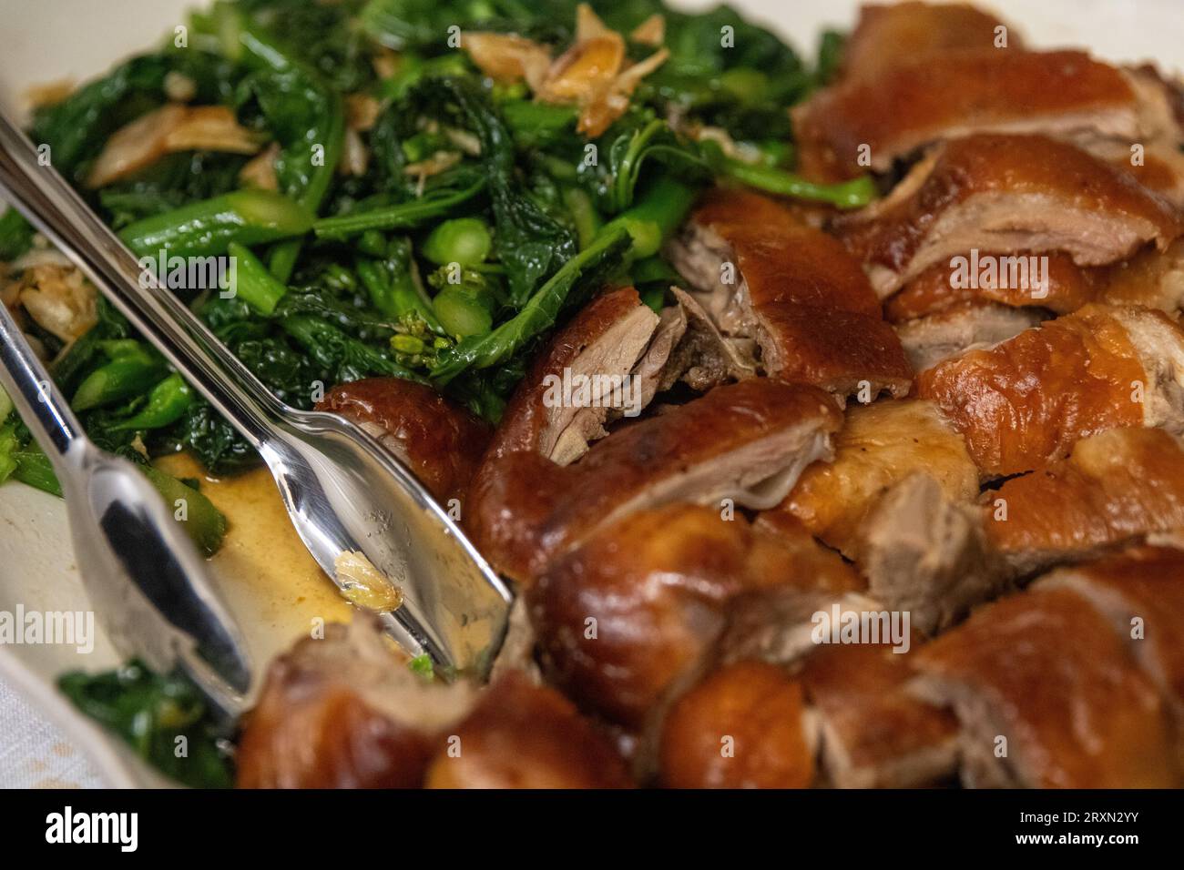 Roasted Duck with Vegetables and serving tongs Stock Photo - Alamy