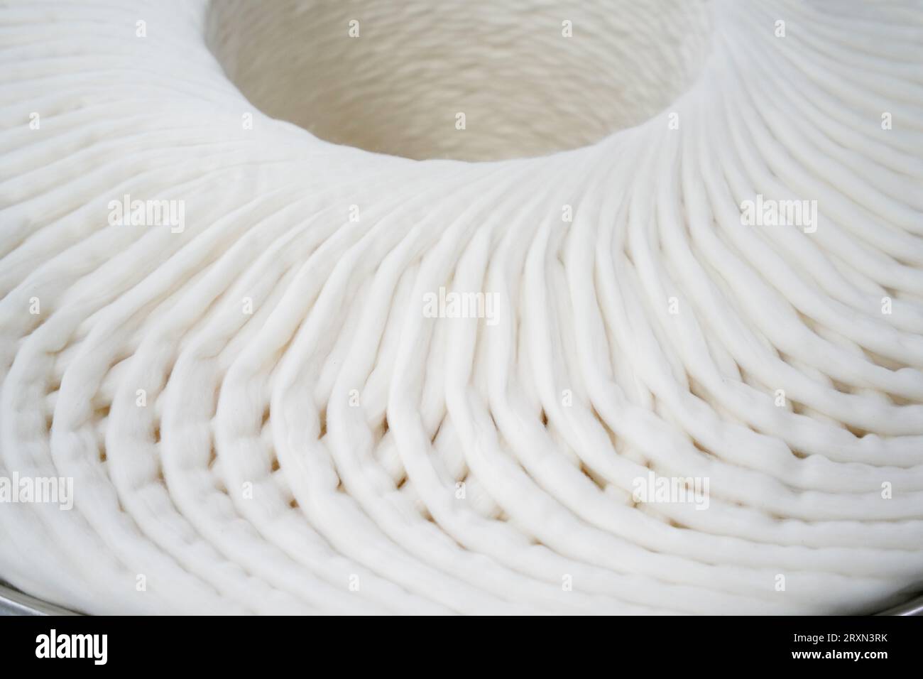 Pure white combed cotton on the production line in a spinning factory ...