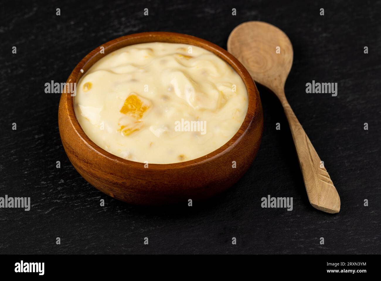 natural banana yogurt of yellow color with the addition of pieces of ...