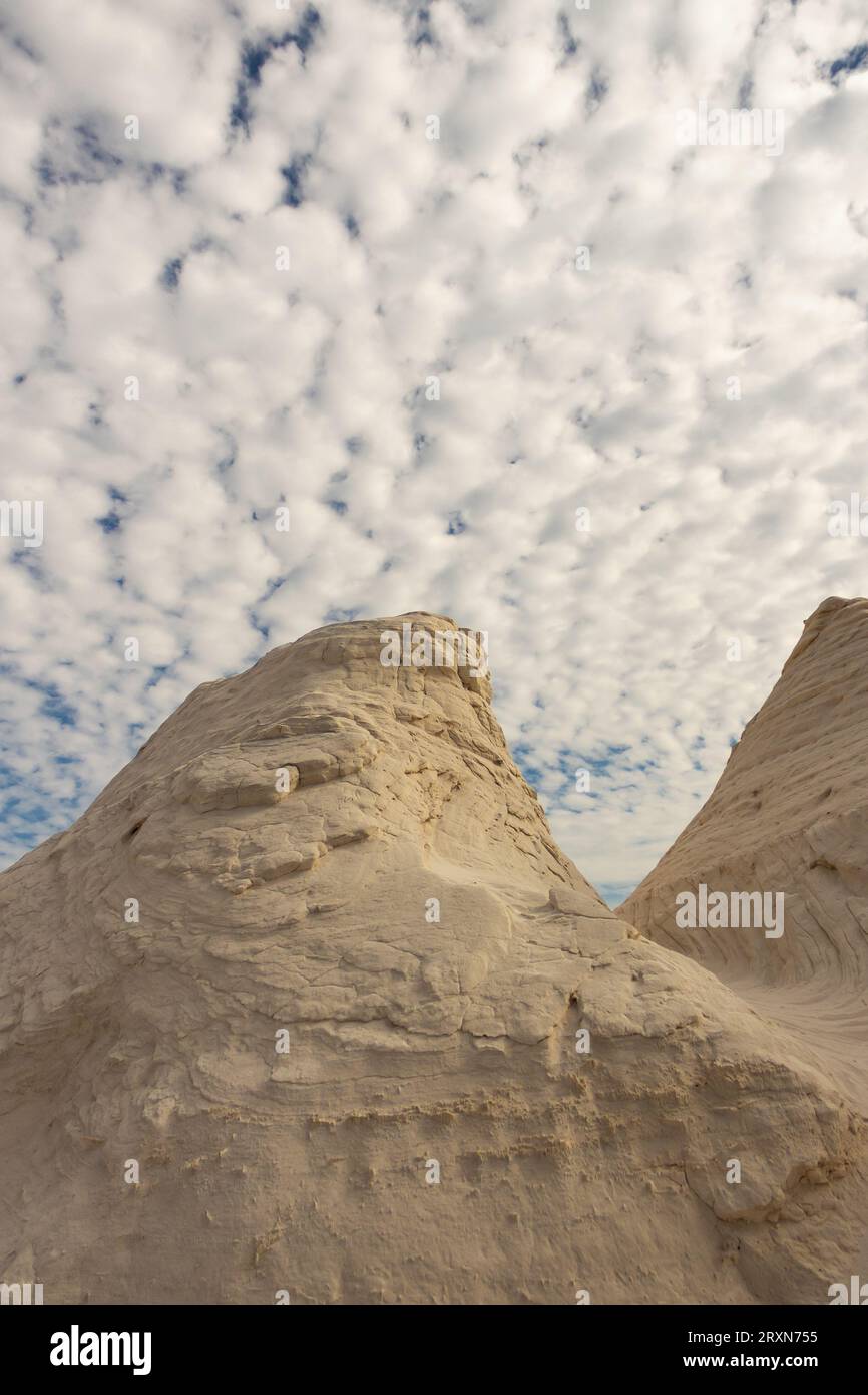 A majestic rock formation rises in the stunning gypsum dunes, while ...