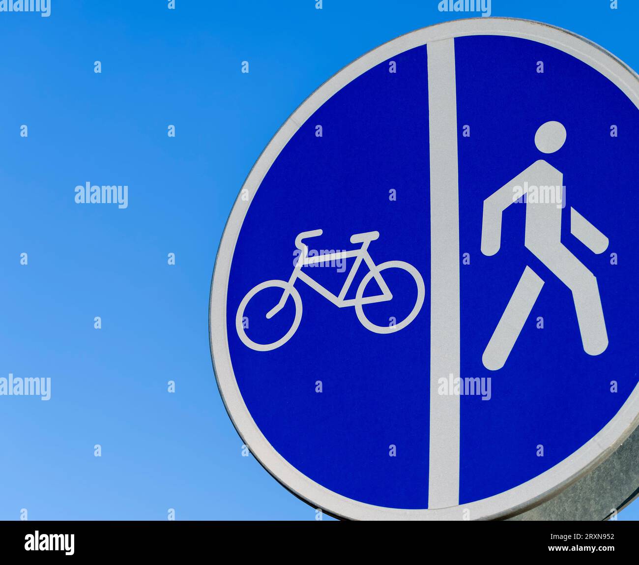 road sign about the separation of pedestrians and cyclists, blue round ...