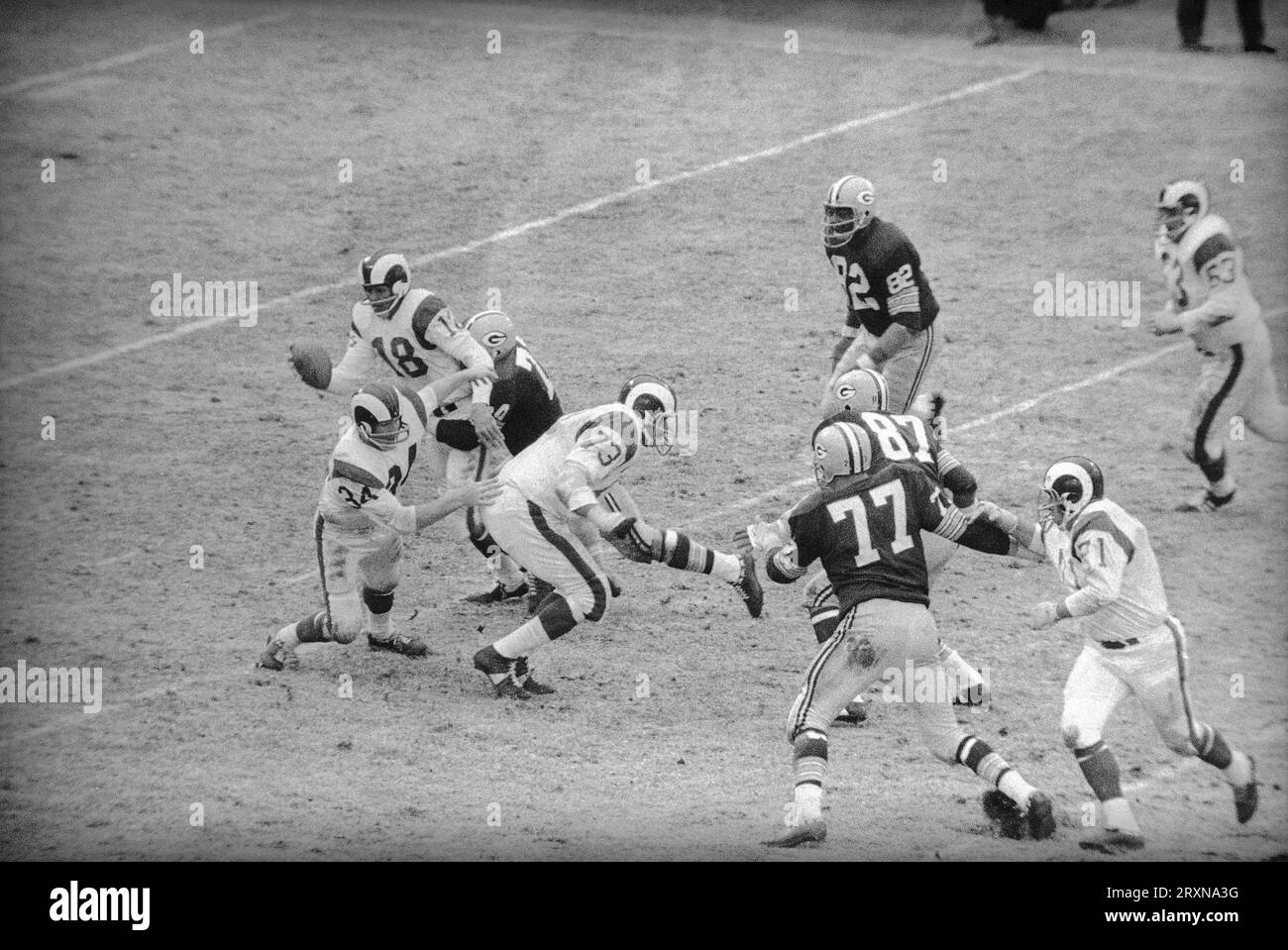 Los Angeles Rams quarterback Roman Gabriel (18) is in the grips of ...