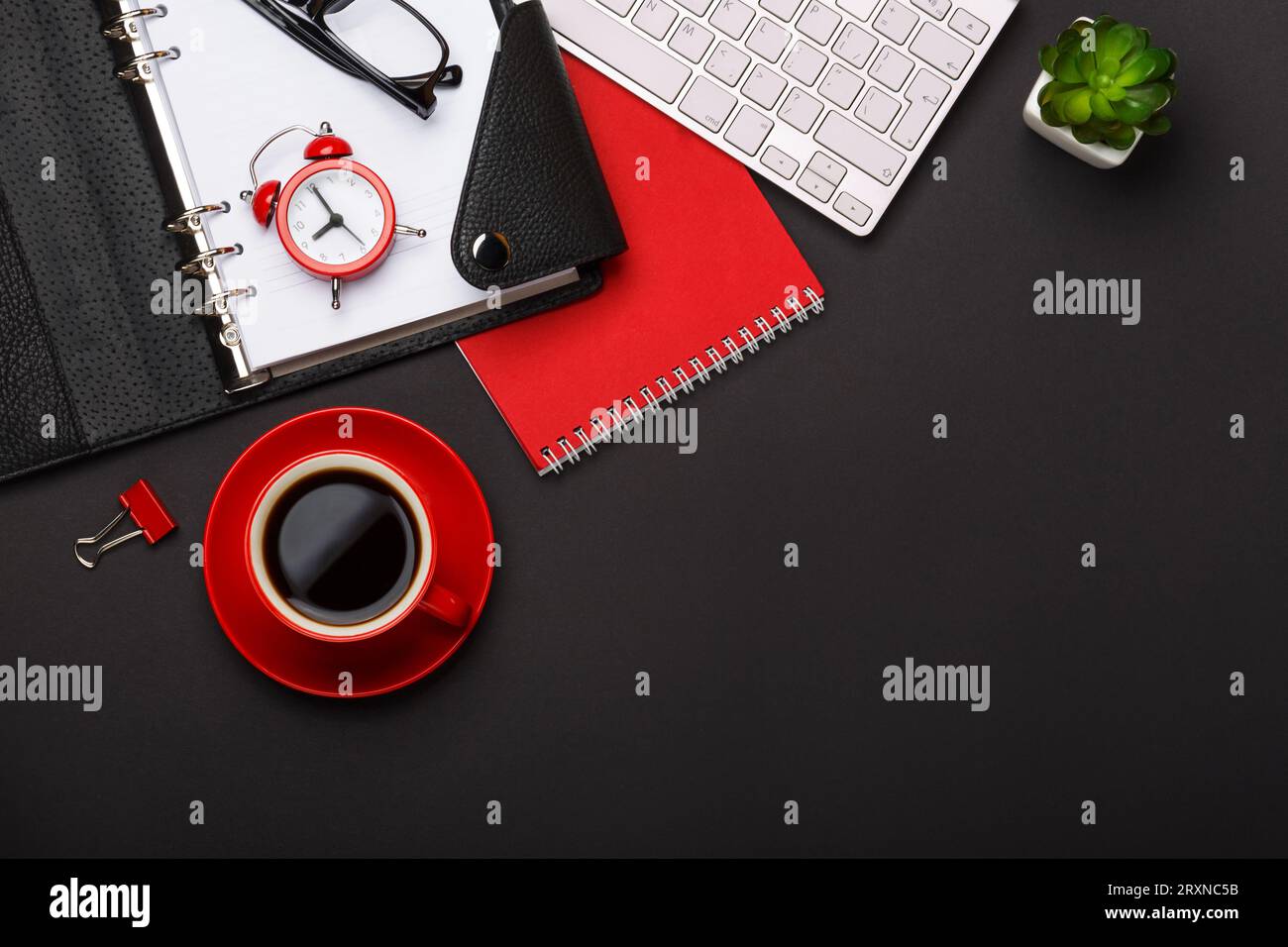 black background red coffee cup note pad alarm clock flower diary ...