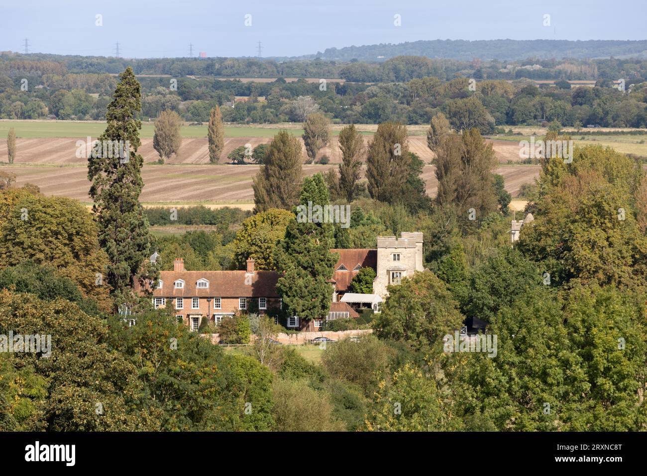 The Manor and St. Peter's Church set in Oxfordshire countryside viewed ...