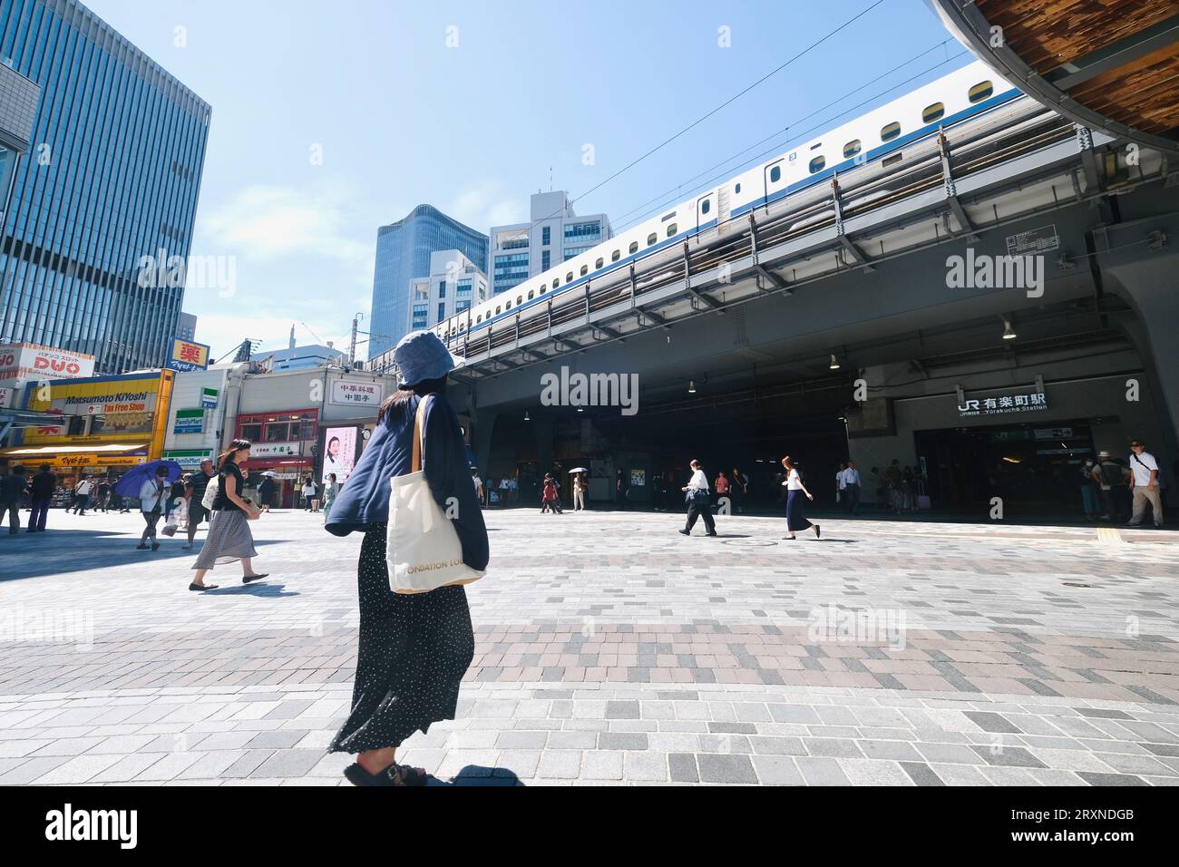 A Japanese high-speed shinkansen train speeds along an elevated section in Ginza, Tokyo, Japan ...