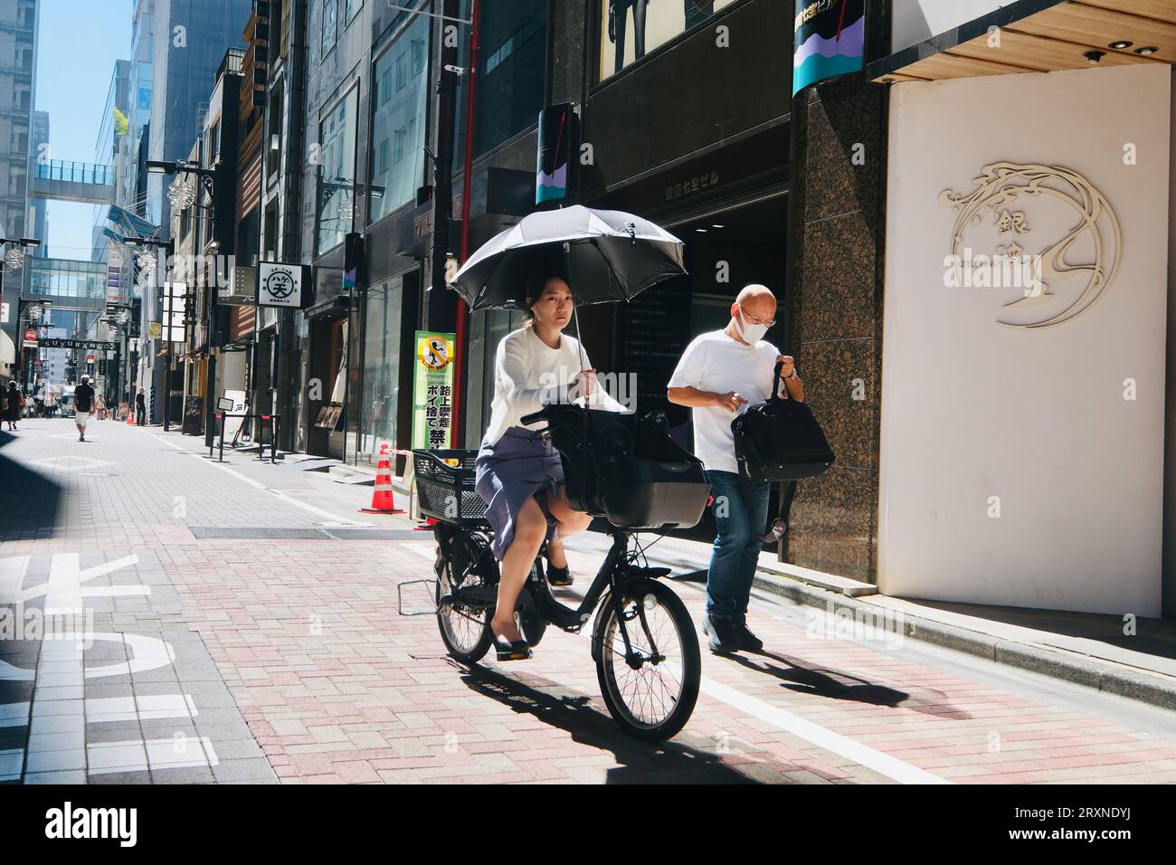 Woman riding a bike in tokyo hi-res stock photography and images - Alamy