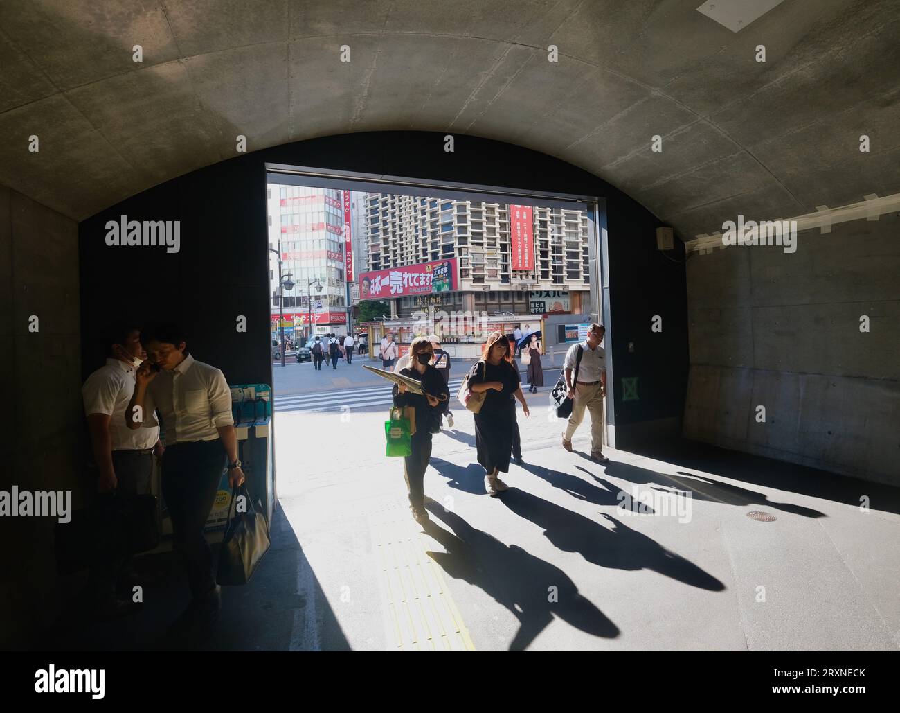 Tokyo commuters pass through an entrance to Simbashi railway station in ...