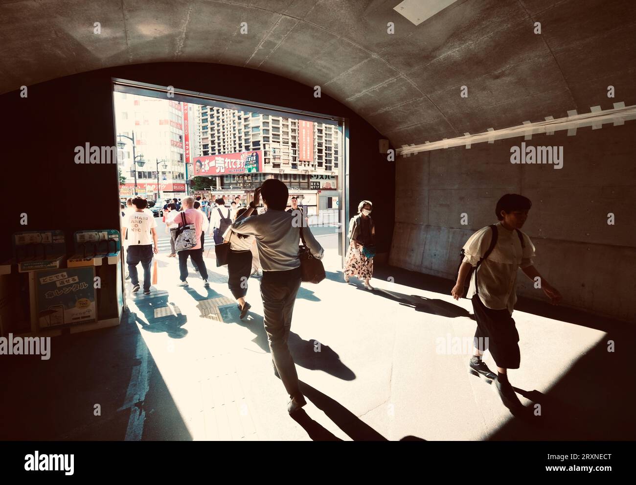 Tokyo commuters pass through an entrance to Simbashi railway station in ...