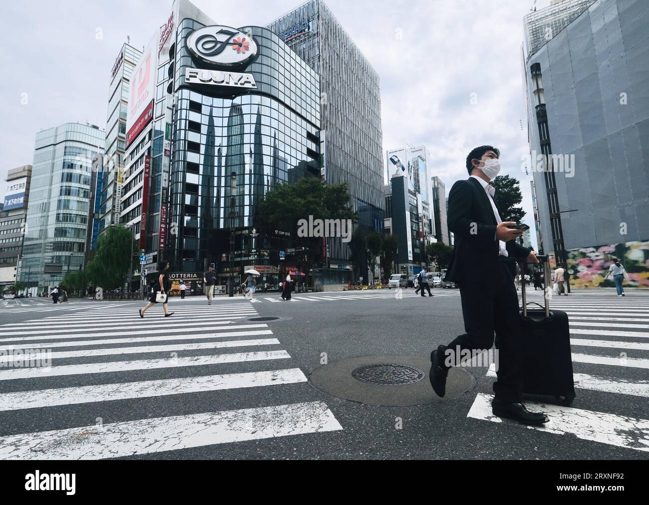 A man walks across a pedestrian crossing in Ginza, Tokyo, Japan Stock ...