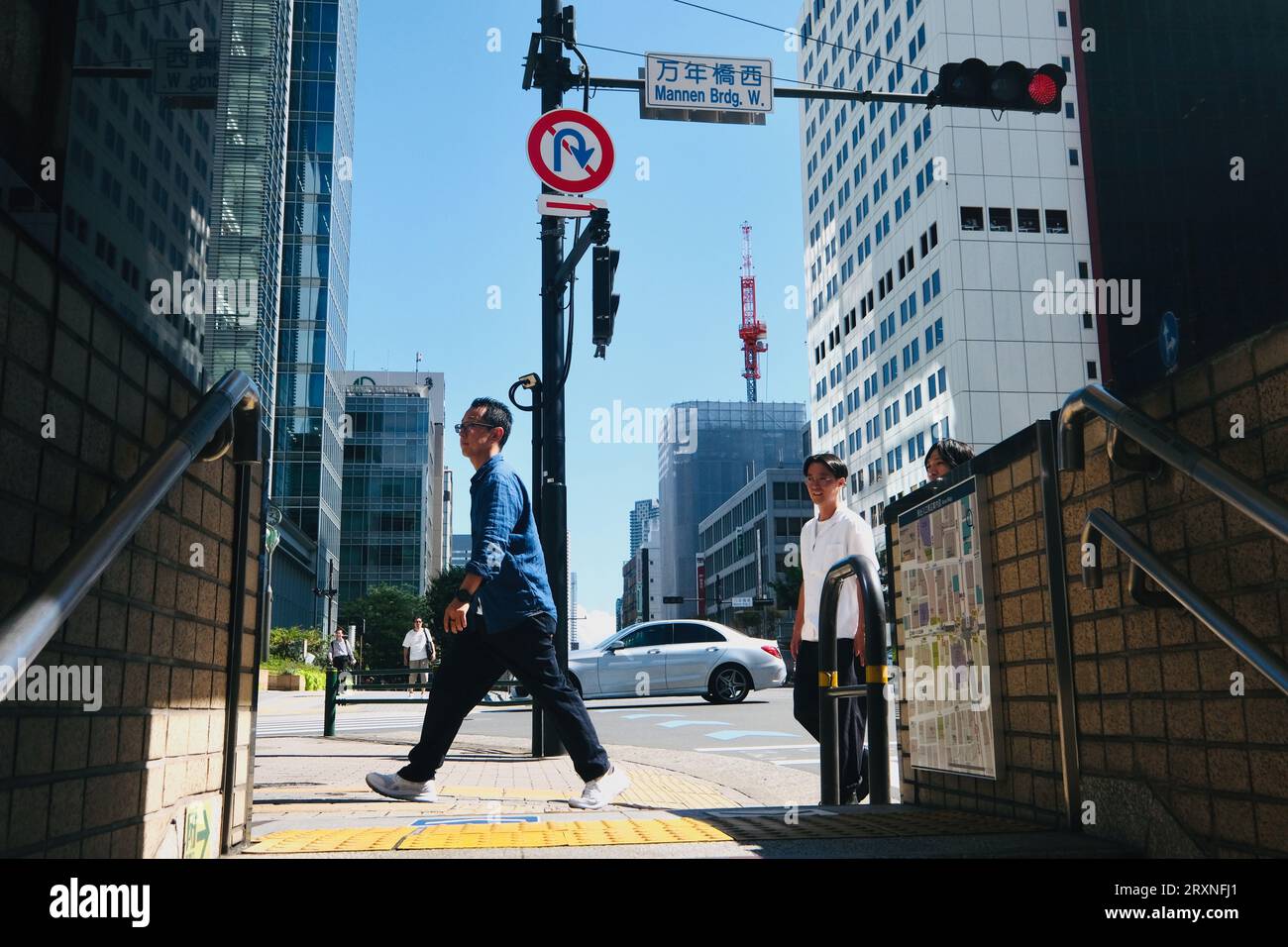 Two Japanese men walk along the street in Ginza, Tokyo, Japan Stock ...