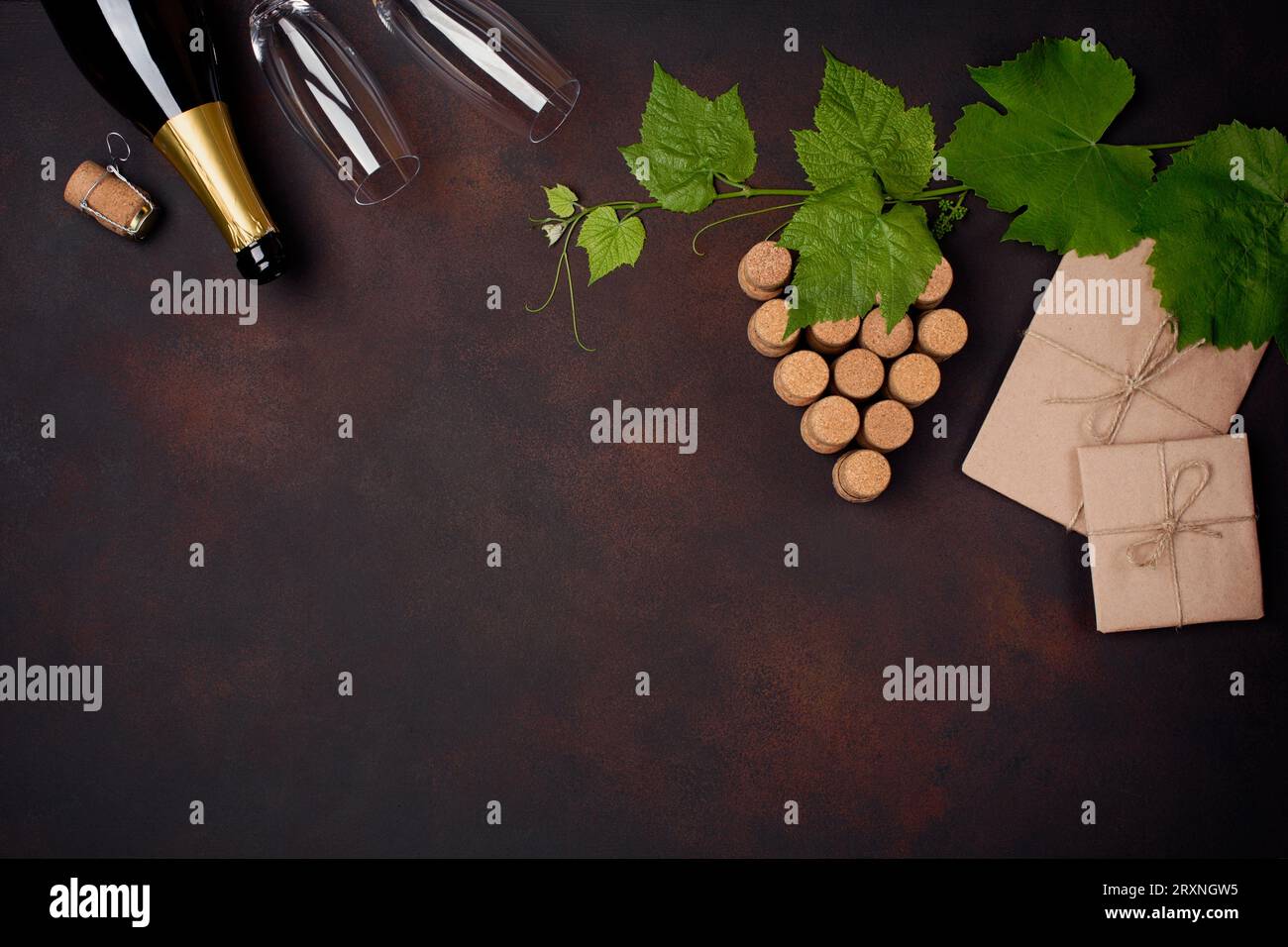 Bottle of champagne, grape bunch of cork with leaves on rusty ...