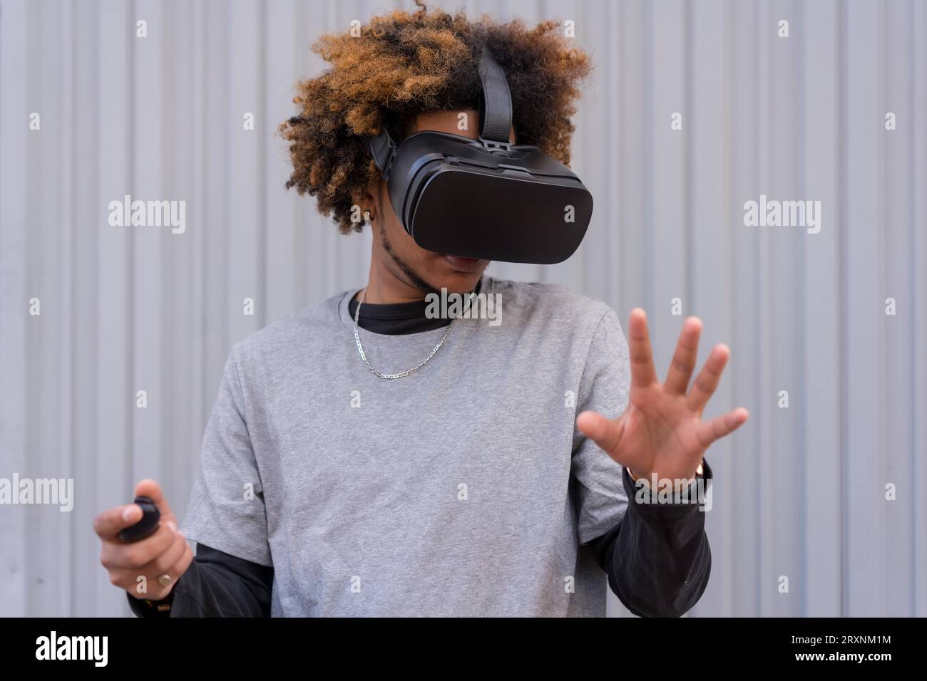 Horizontal photo with urban grey background of a playful man using ...