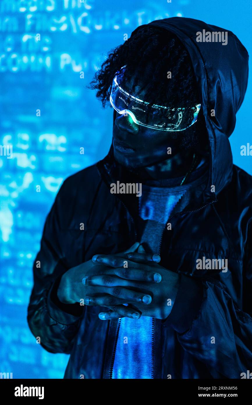 Vertical studio photo with blue neon lights of a futuristic man with ...