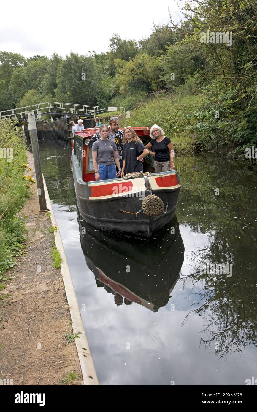 Family enjoying day out on narrow boat on River Avon near Evesham UK ...