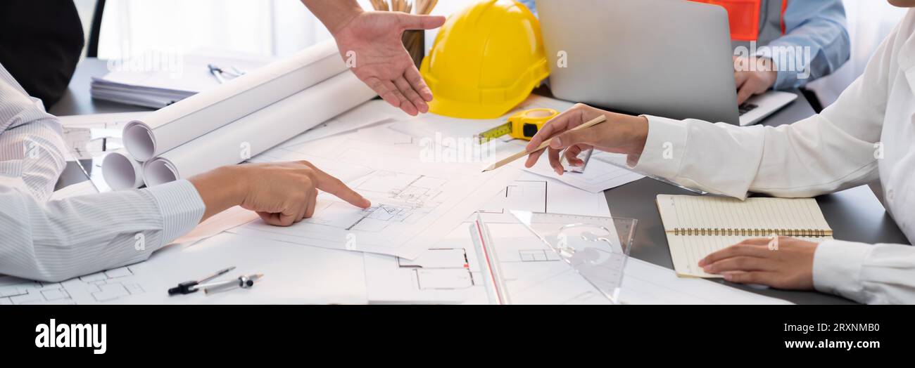 Engineer partner drawing and working on blueprint design together on ...