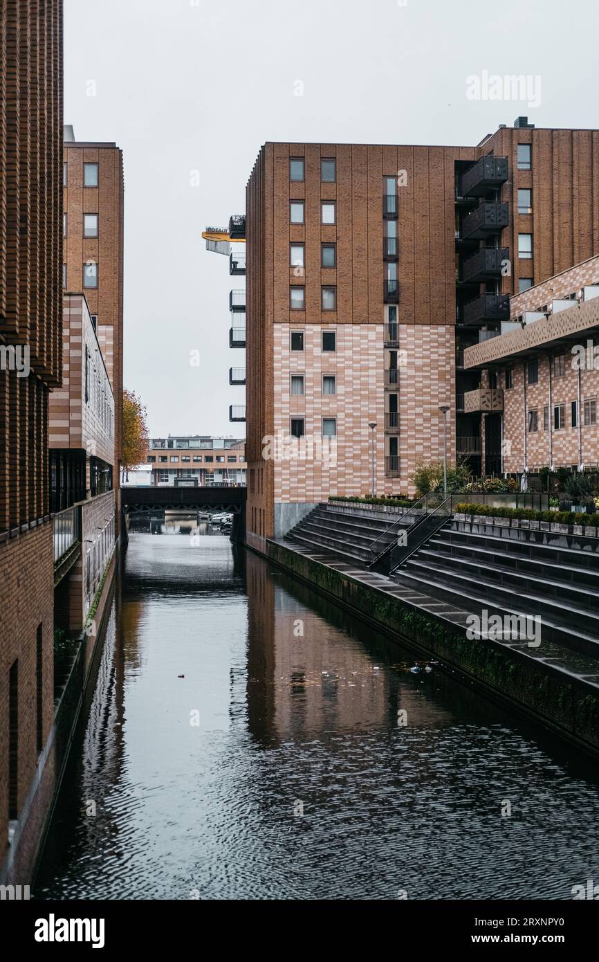 Dutch modern residential buildings reflecting on water canal in Ijburg ...