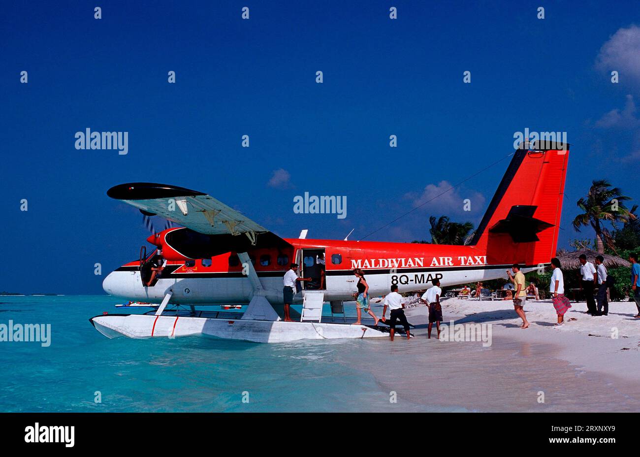 Seaplane and people at beach, White Sands Resort, Ari atol, Indian ...