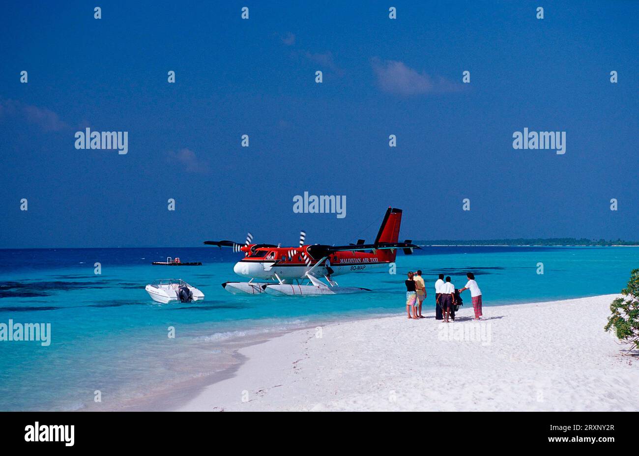 Seaplane and boat at beach, White Sands Resort, Ari atol, Indian Ocean ...