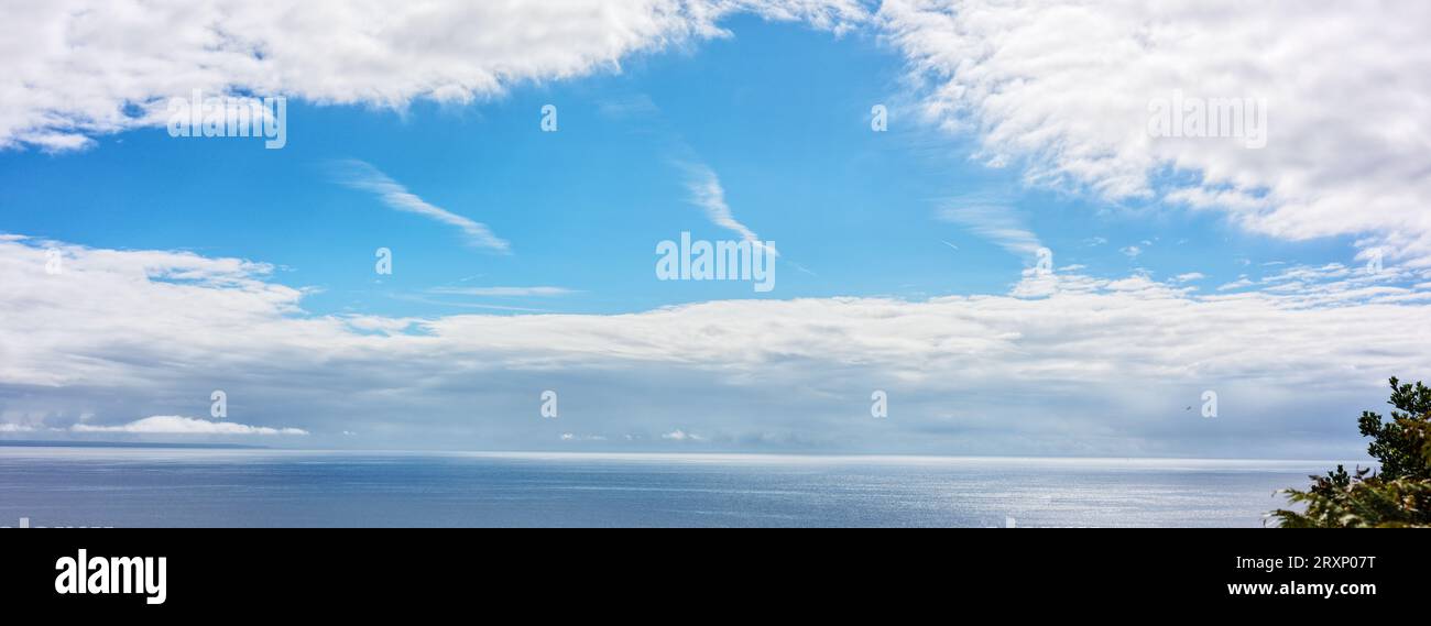 Blue sky and cloud over the Atlantic Ocean outside the village and port ...
